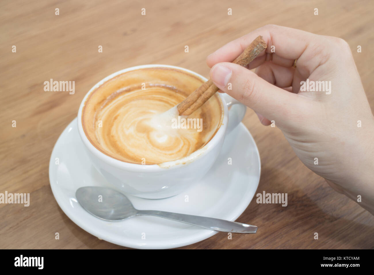 Hand On Hot Cup Of Coffee Latte Stock Photo - Alamy