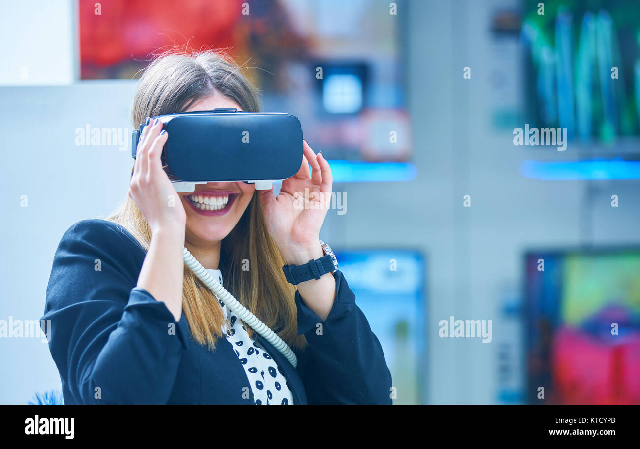 Young woman wearing virtual reality device Stock Photo - Alamy