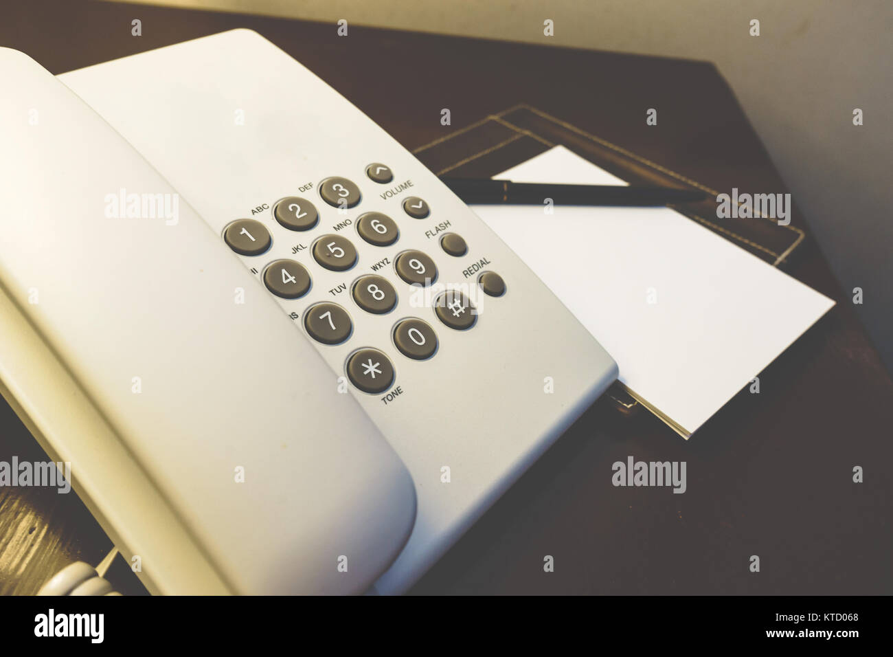 Telephone and Notebook on Table Stock Photo - Alamy
