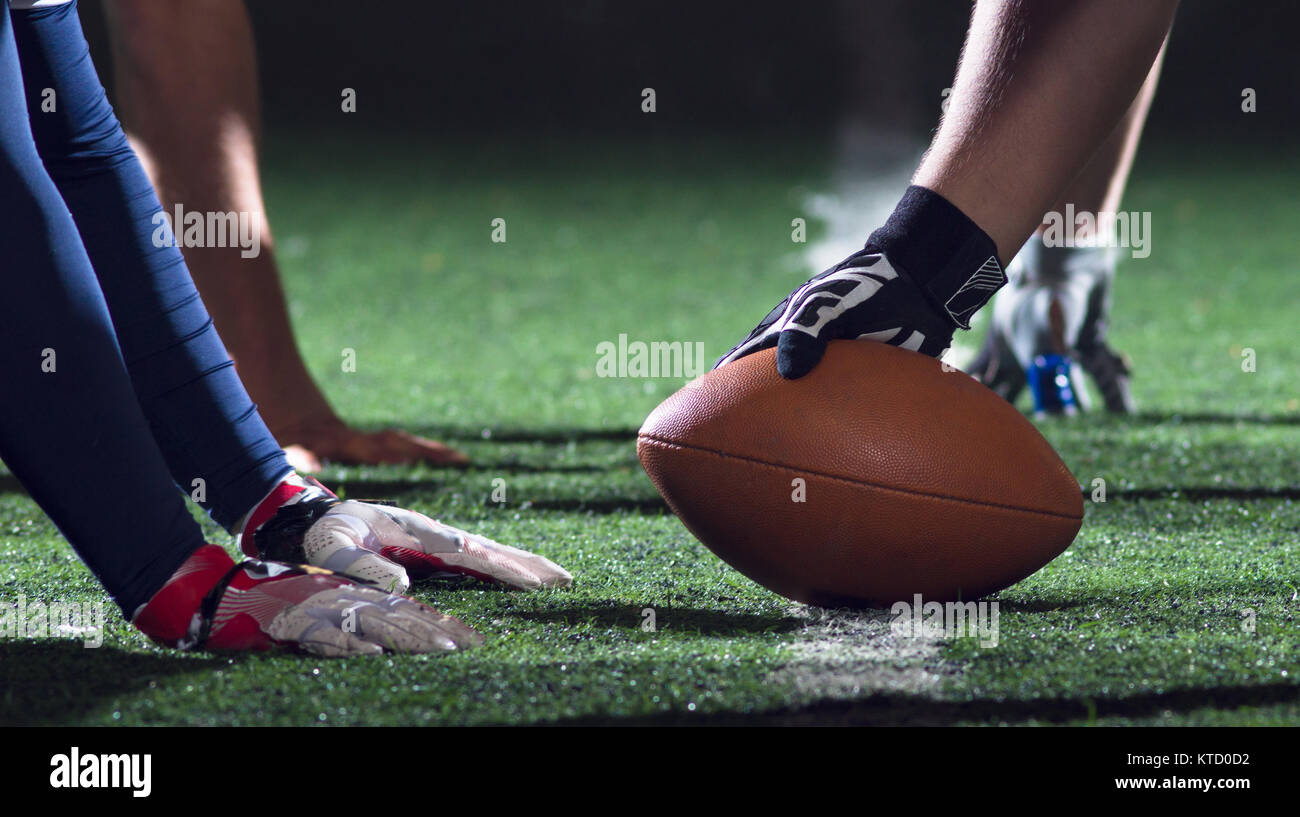 american football players are ready to start on field at night Stock ...