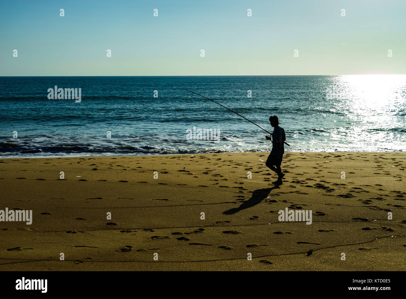 Fisherman walking on beach Sea background Stock Photo - Alamy