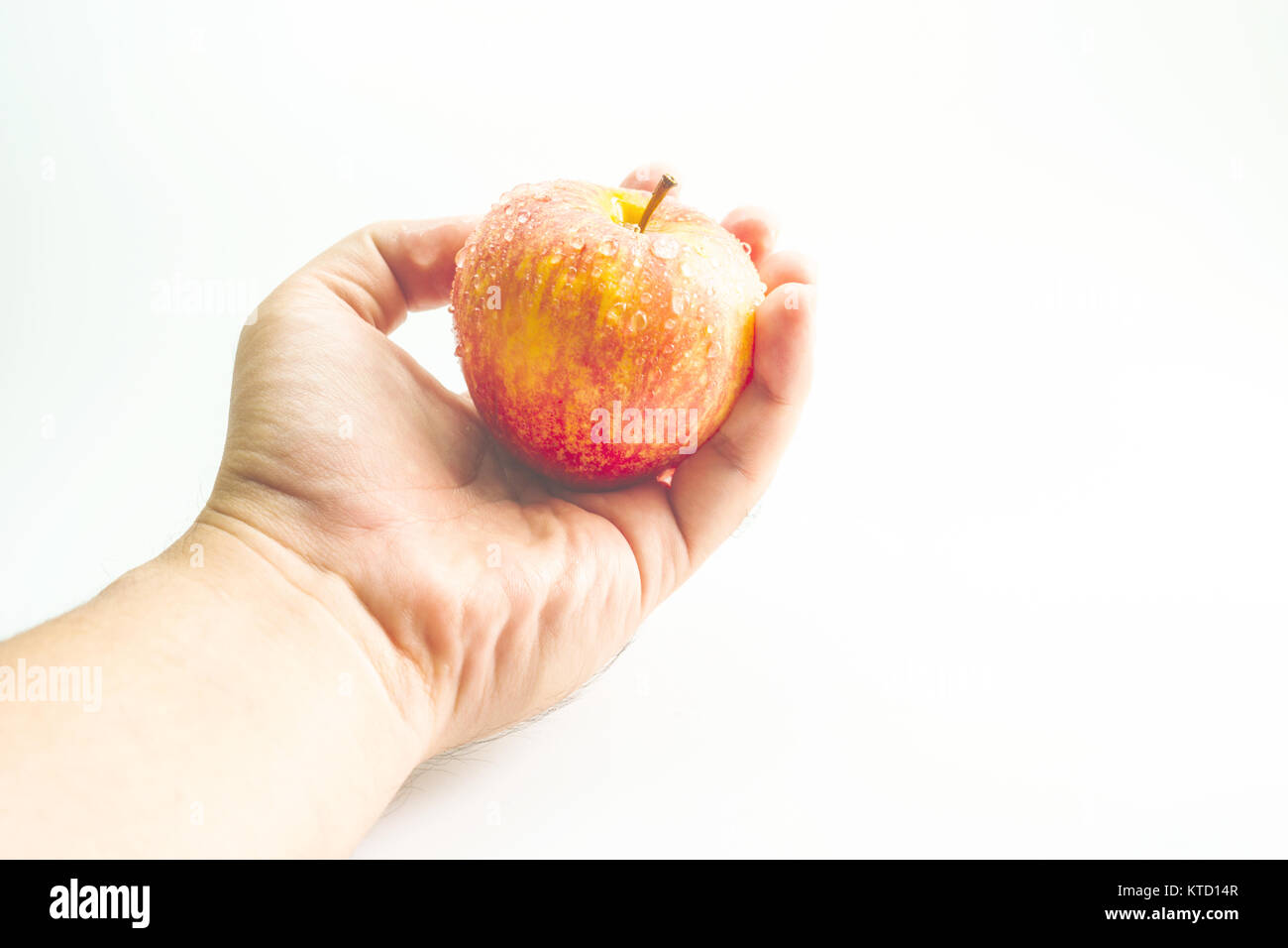 Apple on Hand Isolated on white background Stock Photo - Alamy