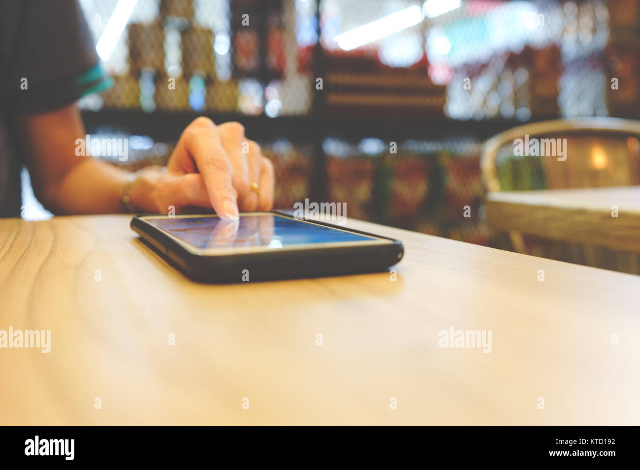 Hand on smartphone on the table Stock Photo - Alamy