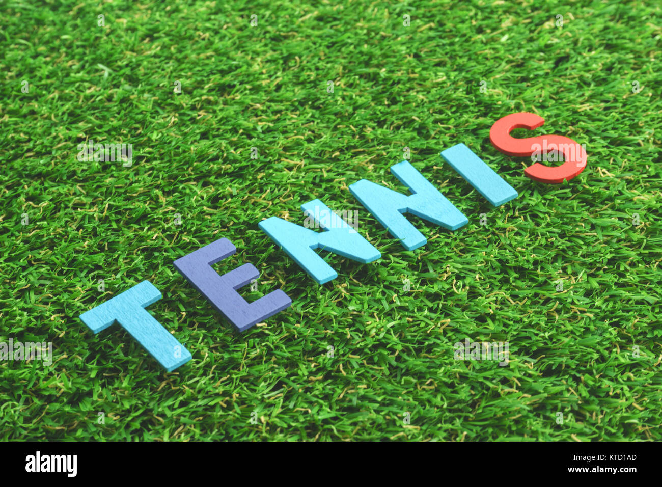 Colorful Wooden Alphabet Word Tennis on green grass background Stock ...