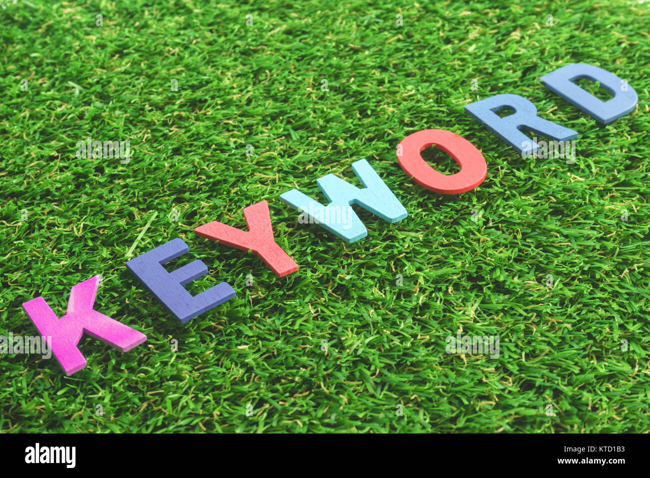 Colorful Wooden Alphabet Word Keyword On Green Grass Background Stock