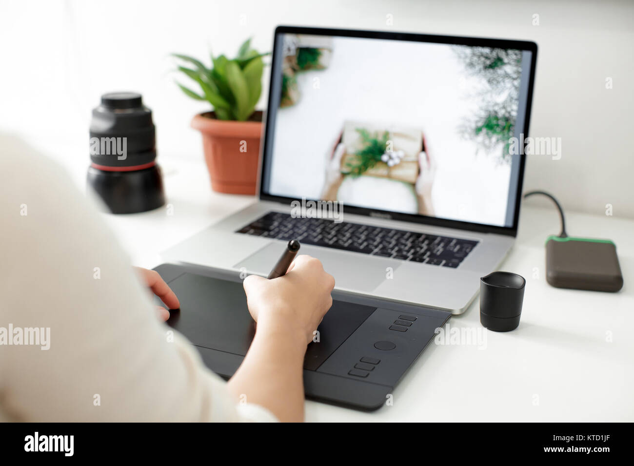 Professional editor using retouching software hi-res stock photography ...