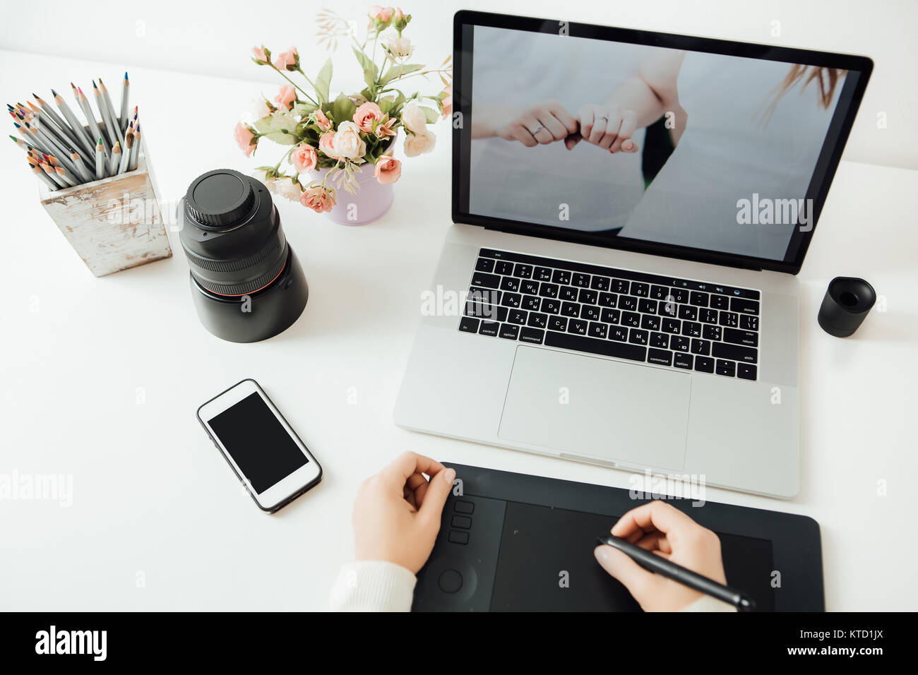 Young photographer using pen retouch hi-res stock photography and ...