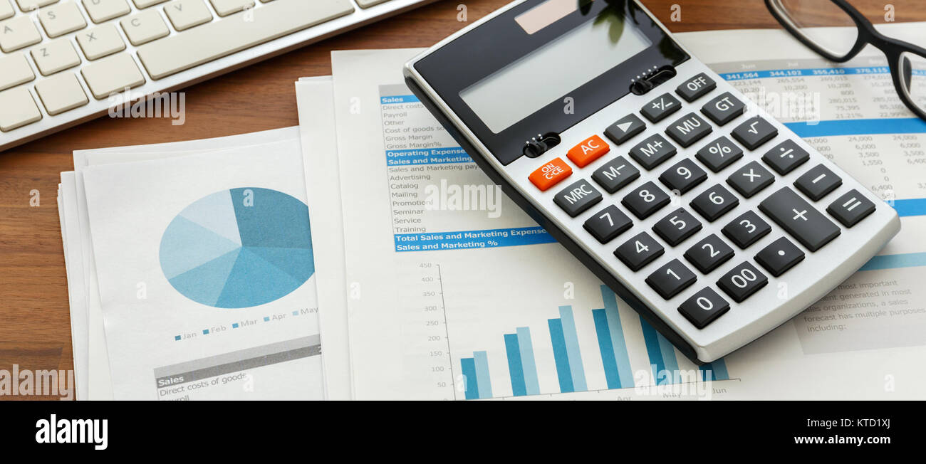 Financial accounting with calculator and financial chart data on wooden ...