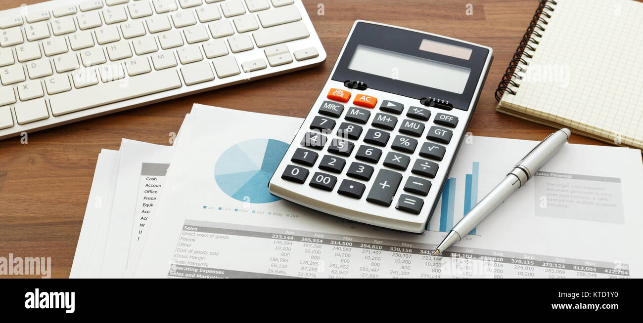 Financial accounting with calculator and financial chart data on wooden ...