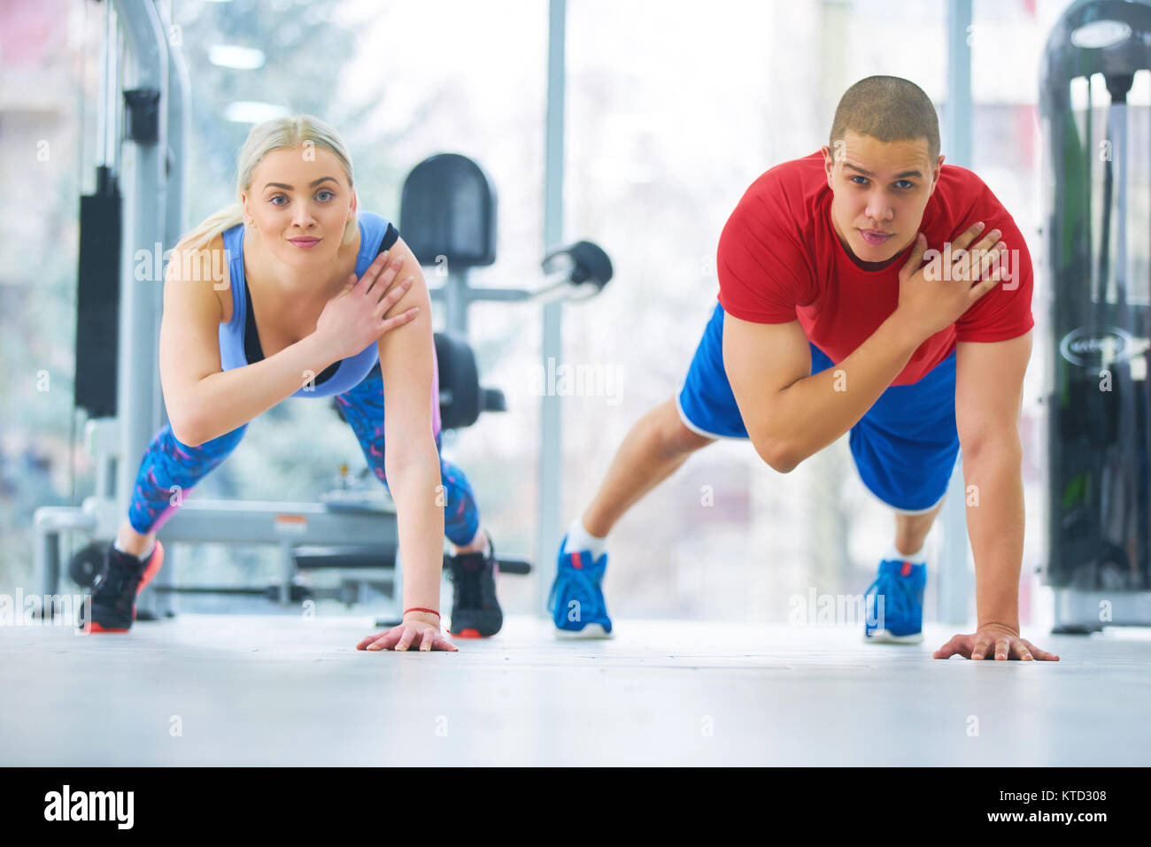 Group having functional fitness training with kettlebell in sport gym ...