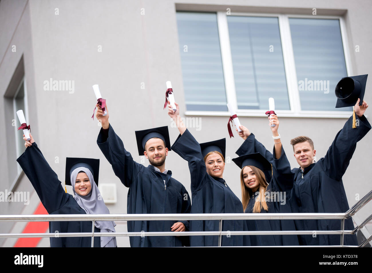Young people graduating, celebration Stock Photo - Alamy