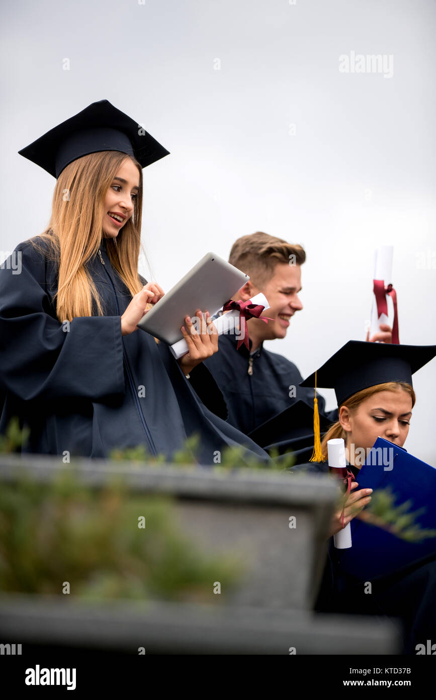 Young people graduating, celebration Stock Photo - Alamy