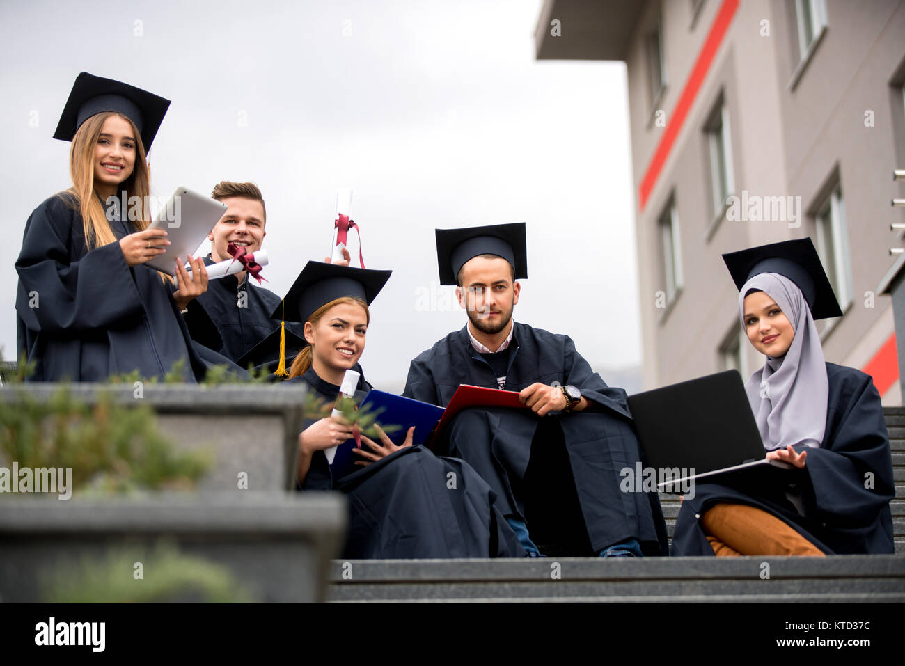 Young people graduating, celebration Stock Photo - Alamy