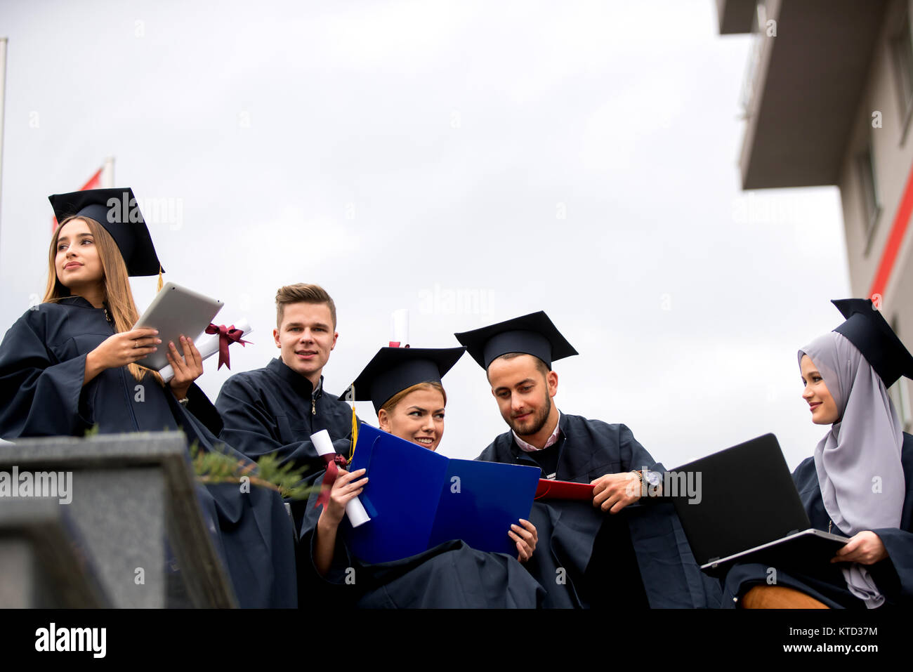 Young people graduating, celebration Stock Photo - Alamy