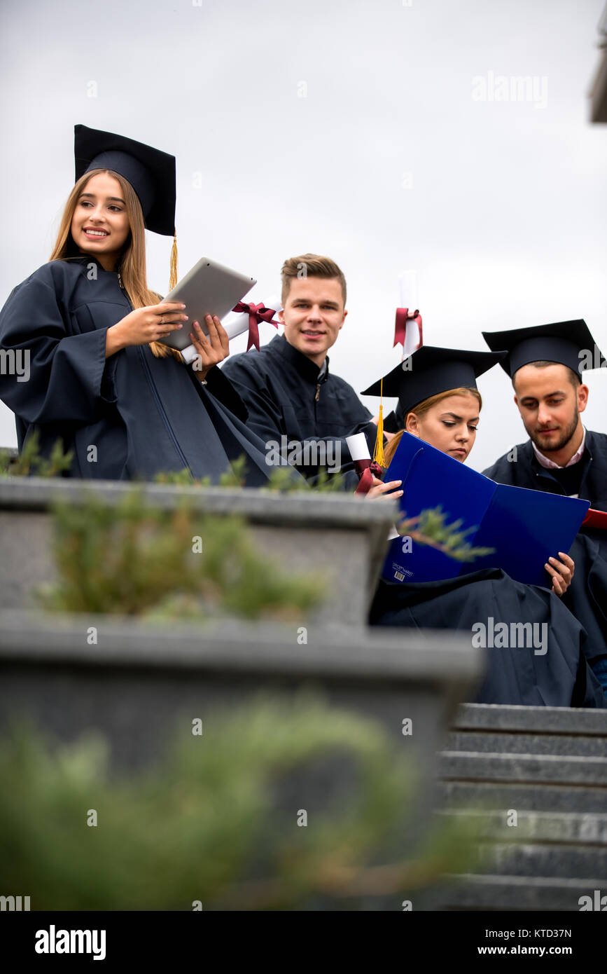 Young people graduating, celebration Stock Photo - Alamy