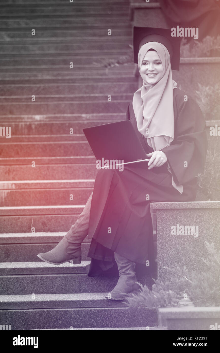 Pretty young female graduate wearing hijab Stock Photo - Alamy
