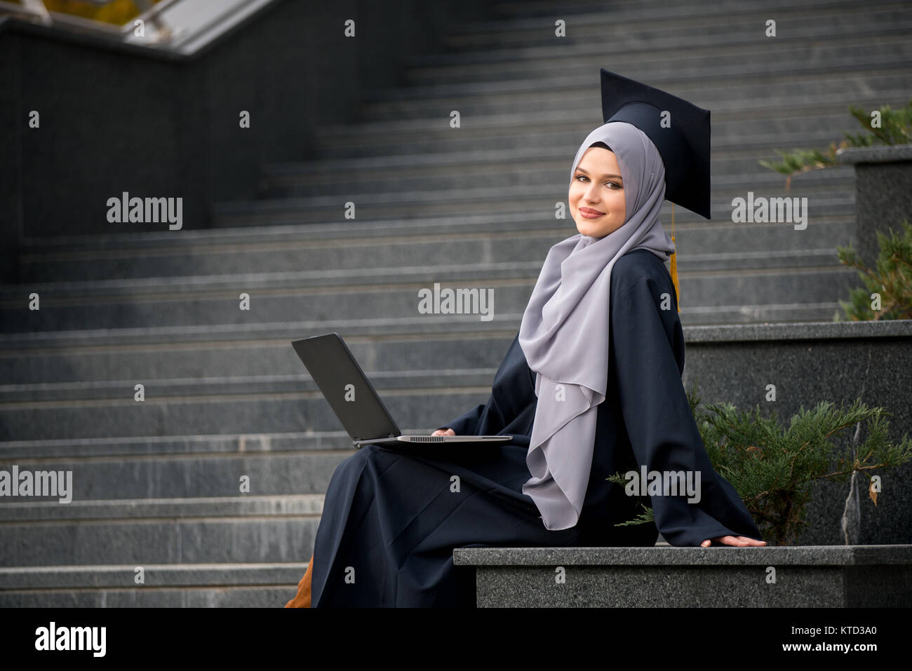 Pretty young female graduate wearing hijab Stock Photo - Alamy