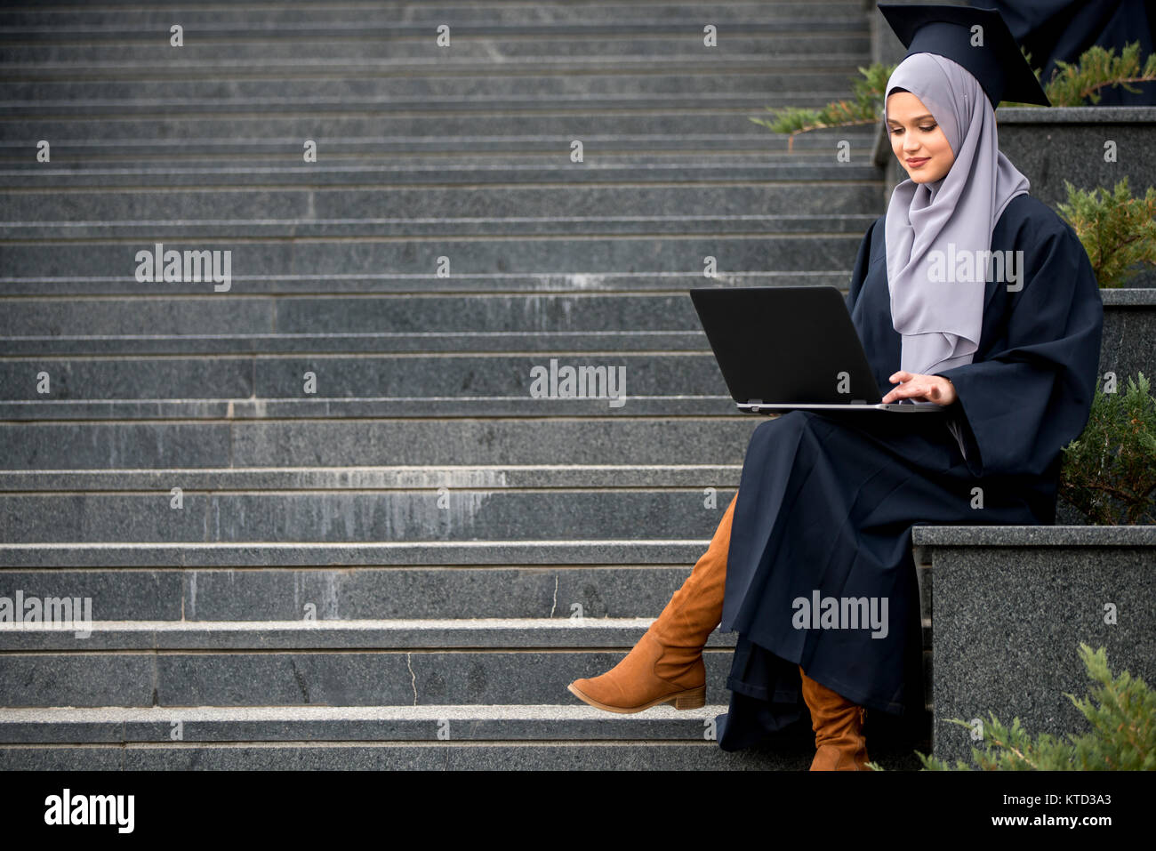 Pretty young female graduate wearing hijab Stock Photo - Alamy