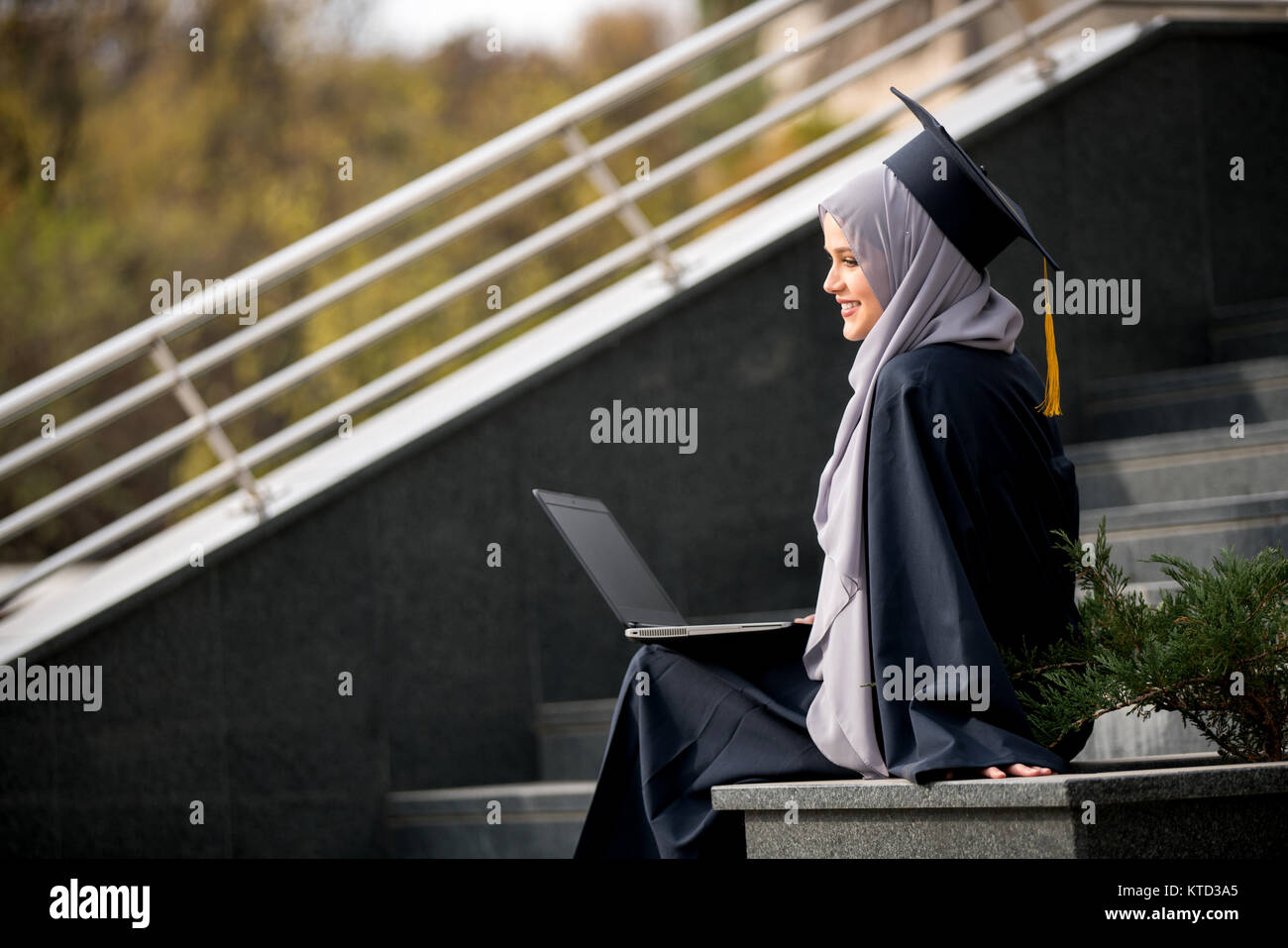Pretty young female graduate wearing hijab Stock Photo - Alamy