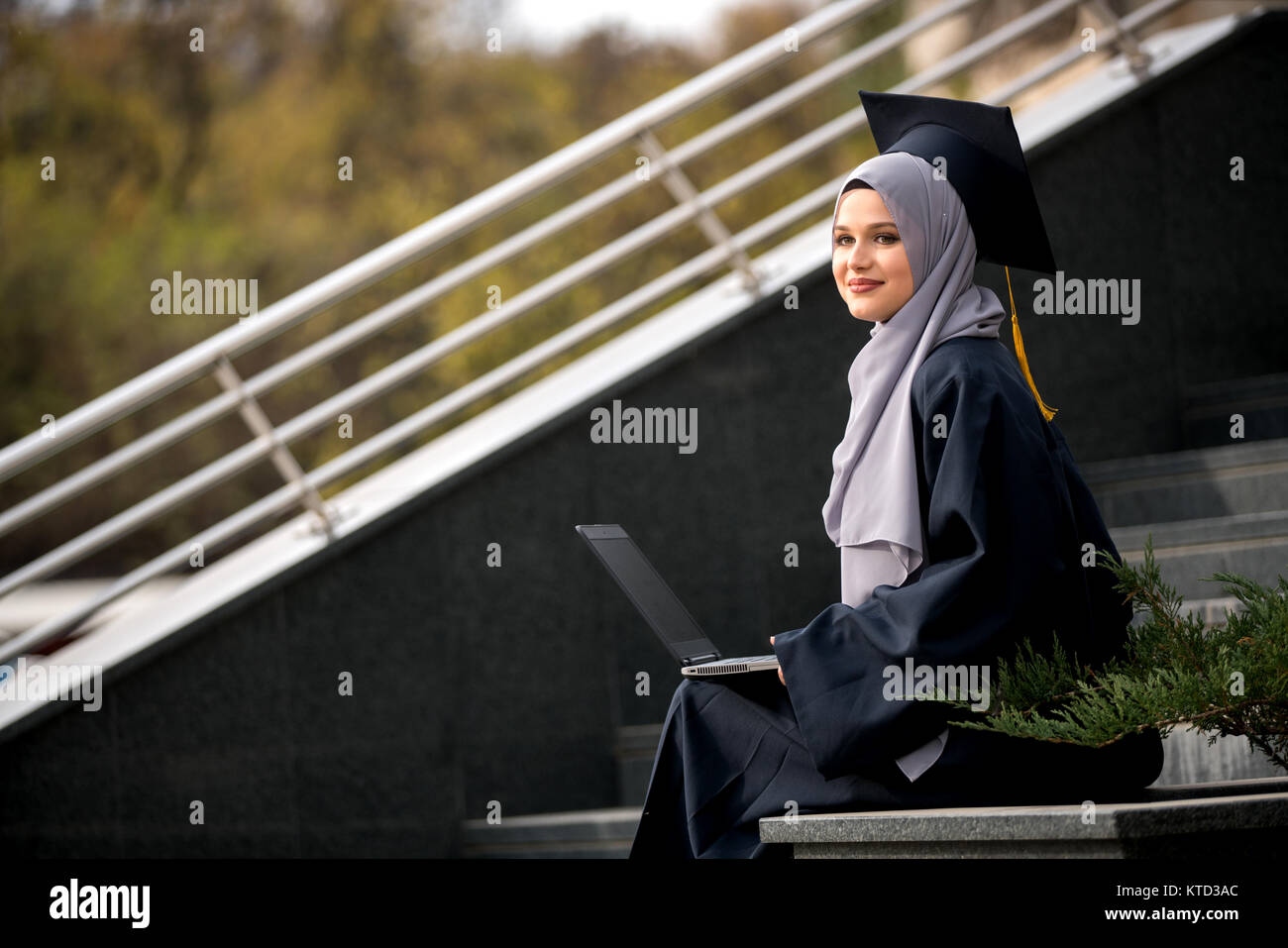 Pretty young female graduate wearing hijab Stock Photo - Alamy