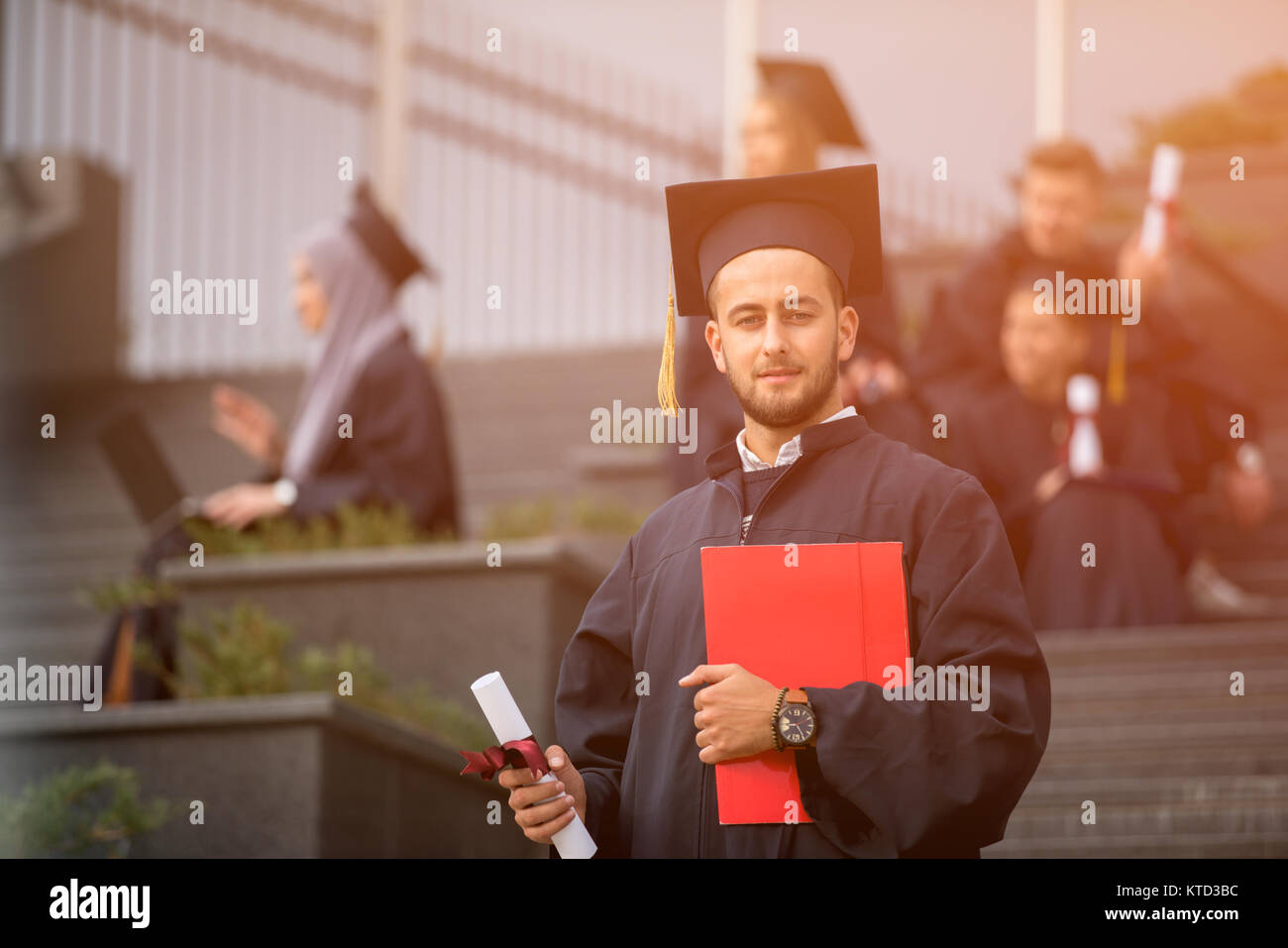 Young proud and confident graduate posing for a photo Stock Photo - Alamy