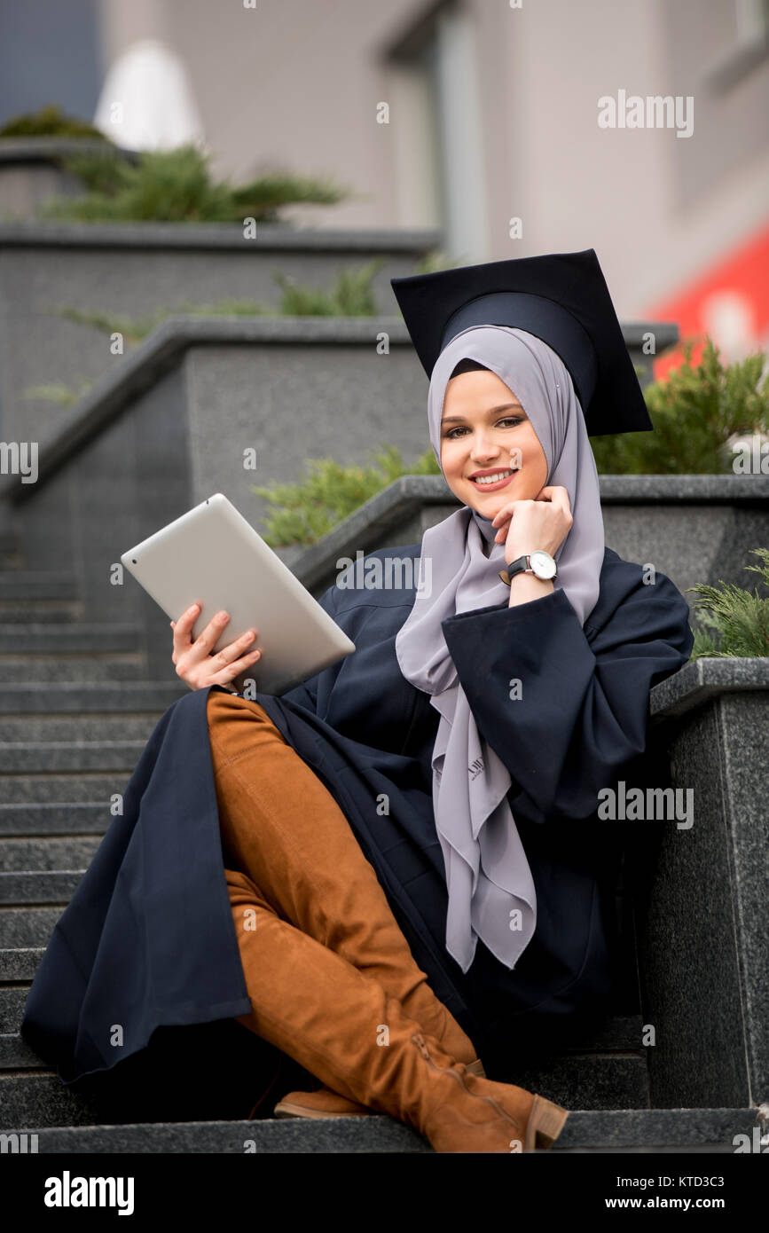 Pretty young female graduate wearing hijab Stock Photo - Alamy