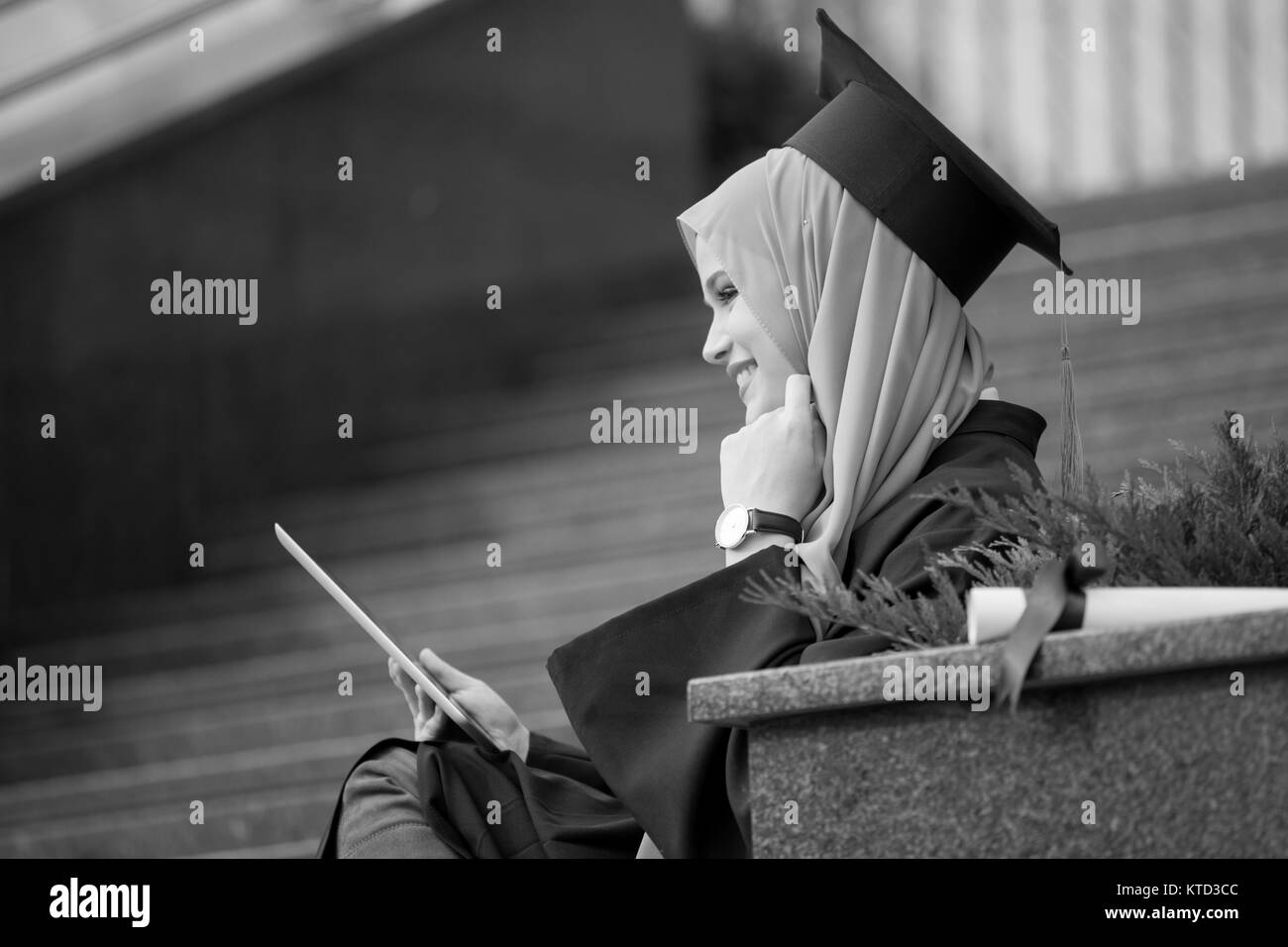 Pretty young female graduate wearing hijab Stock Photo - Alamy