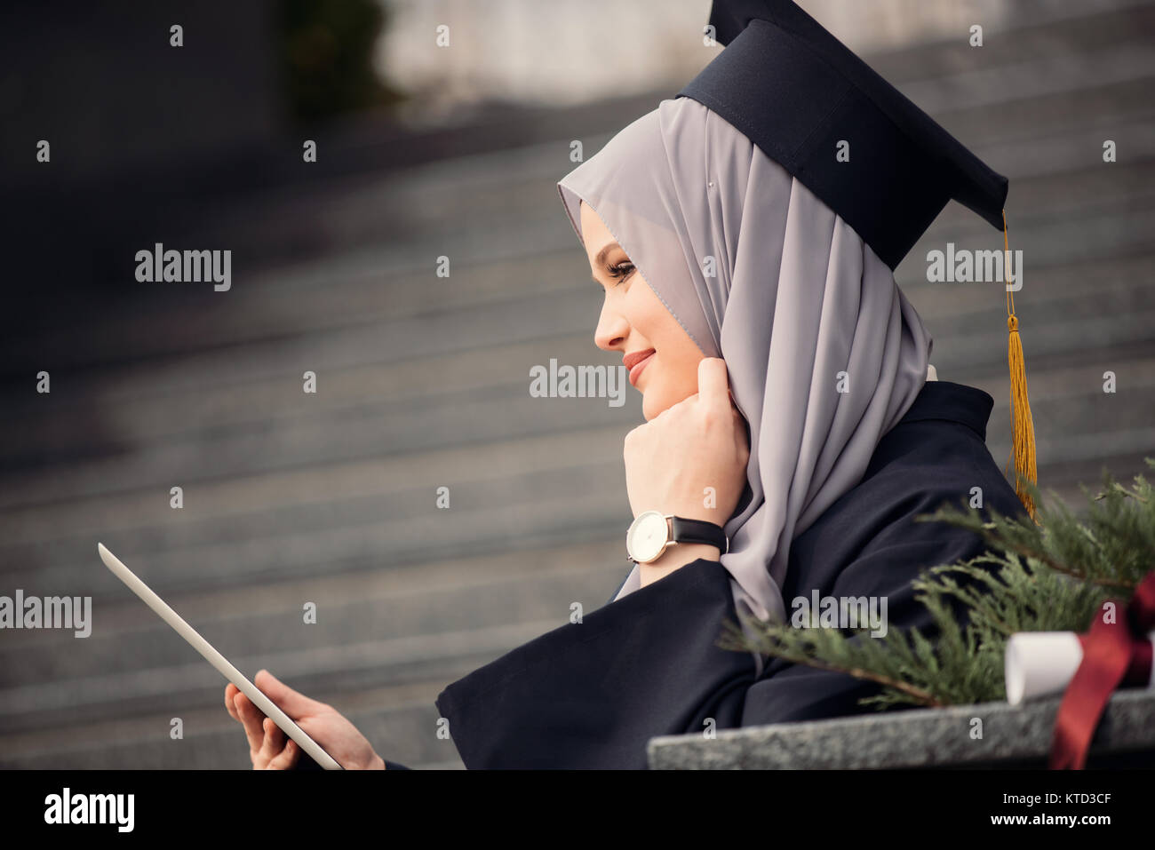 Pretty young female graduate wearing hijab Stock Photo - Alamy
