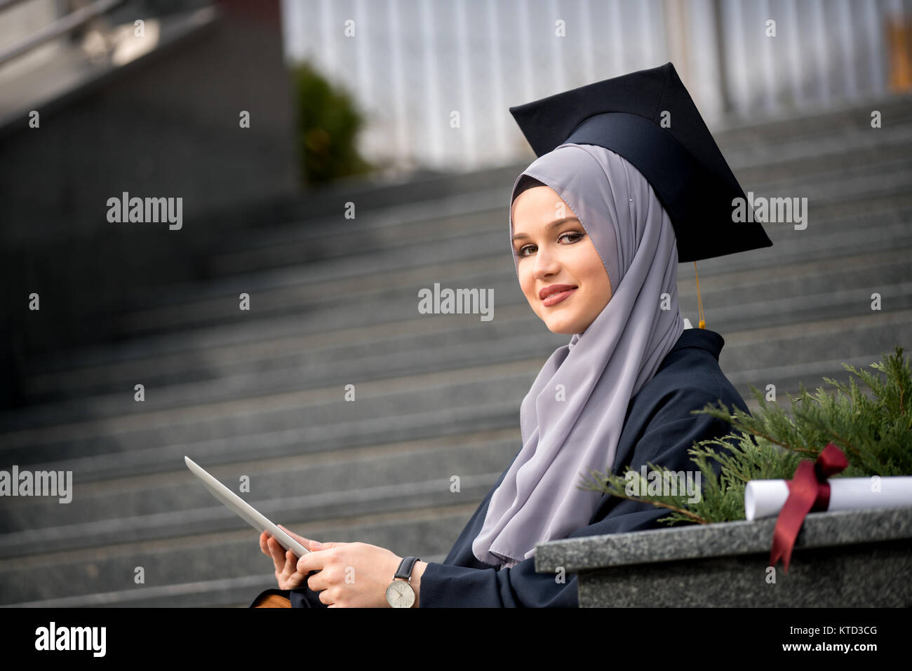 Pretty young female graduate wearing hijab Stock Photo - Alamy