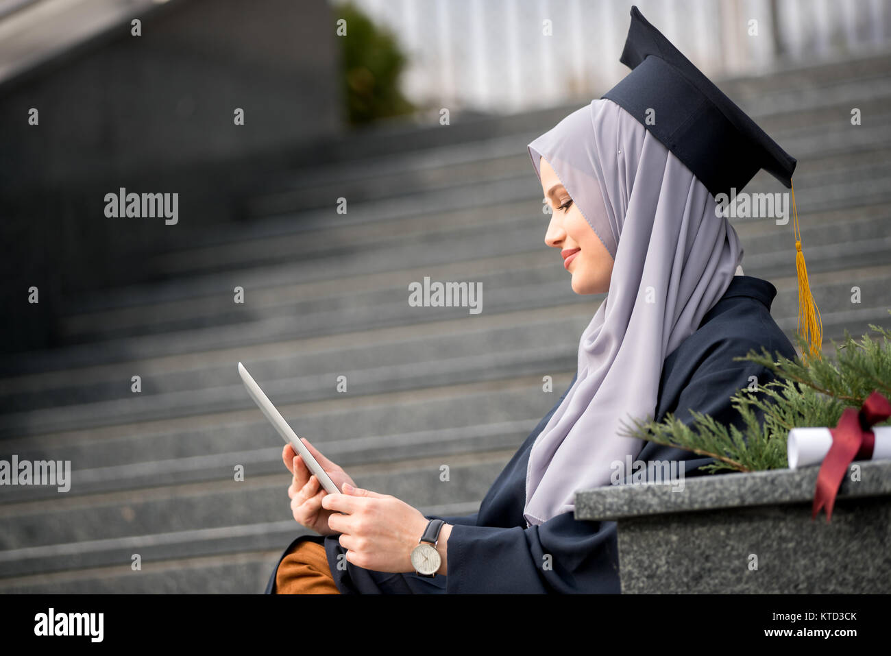 Pretty young female graduate wearing hijab Stock Photo - Alamy