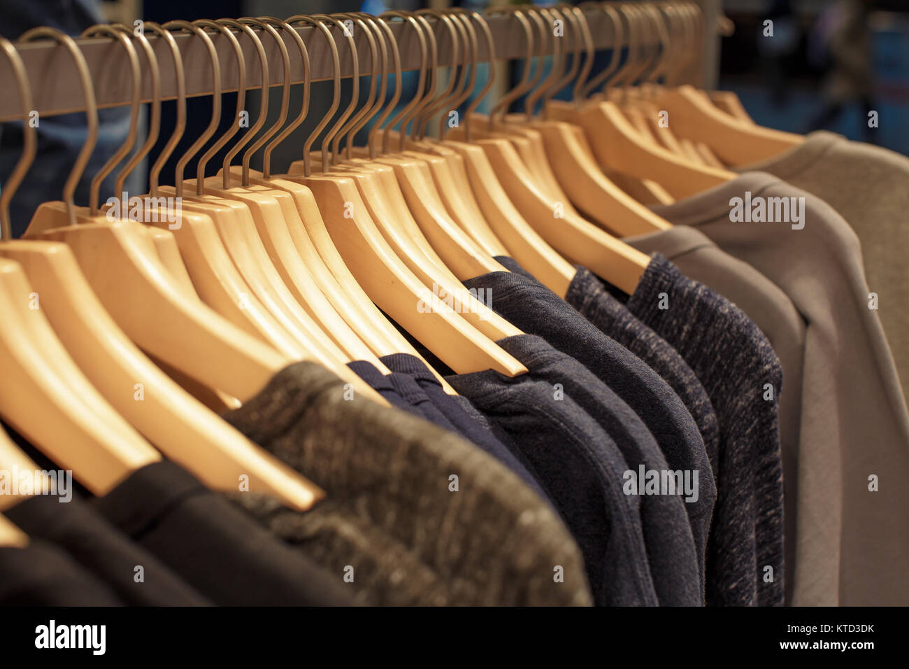 dark womens clothes on wood hangers on rack in fashion store Stock ...