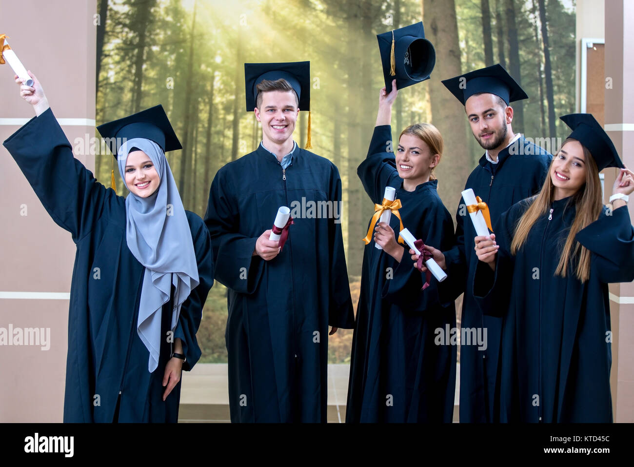 Group of Diverse International Graduating Students Celebrating, sitting ...