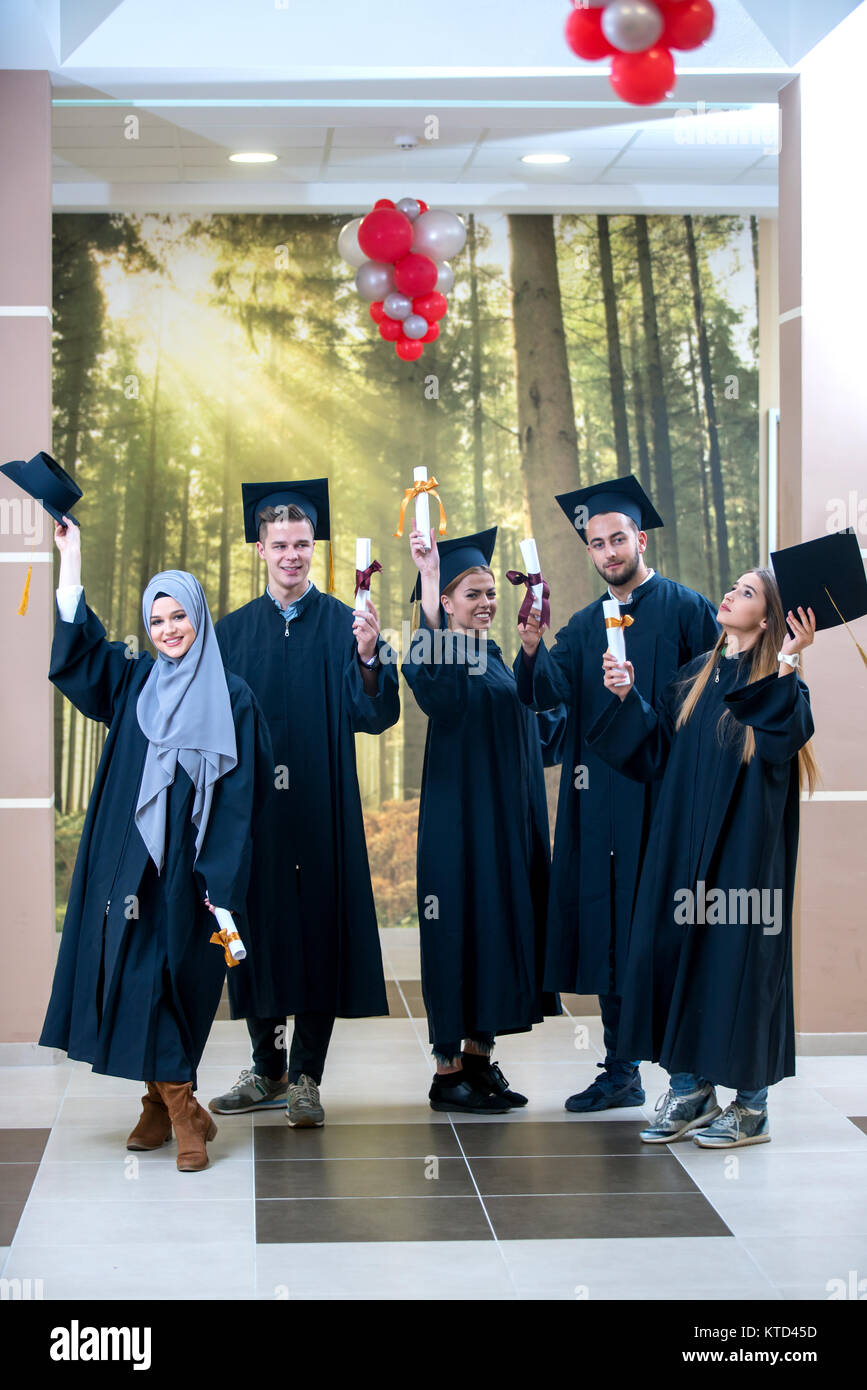 Group of Diverse International Graduating Students Celebrating, sitting ...