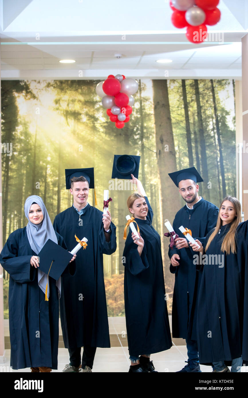 Group of Diverse International Graduating Students Celebrating, sitting ...