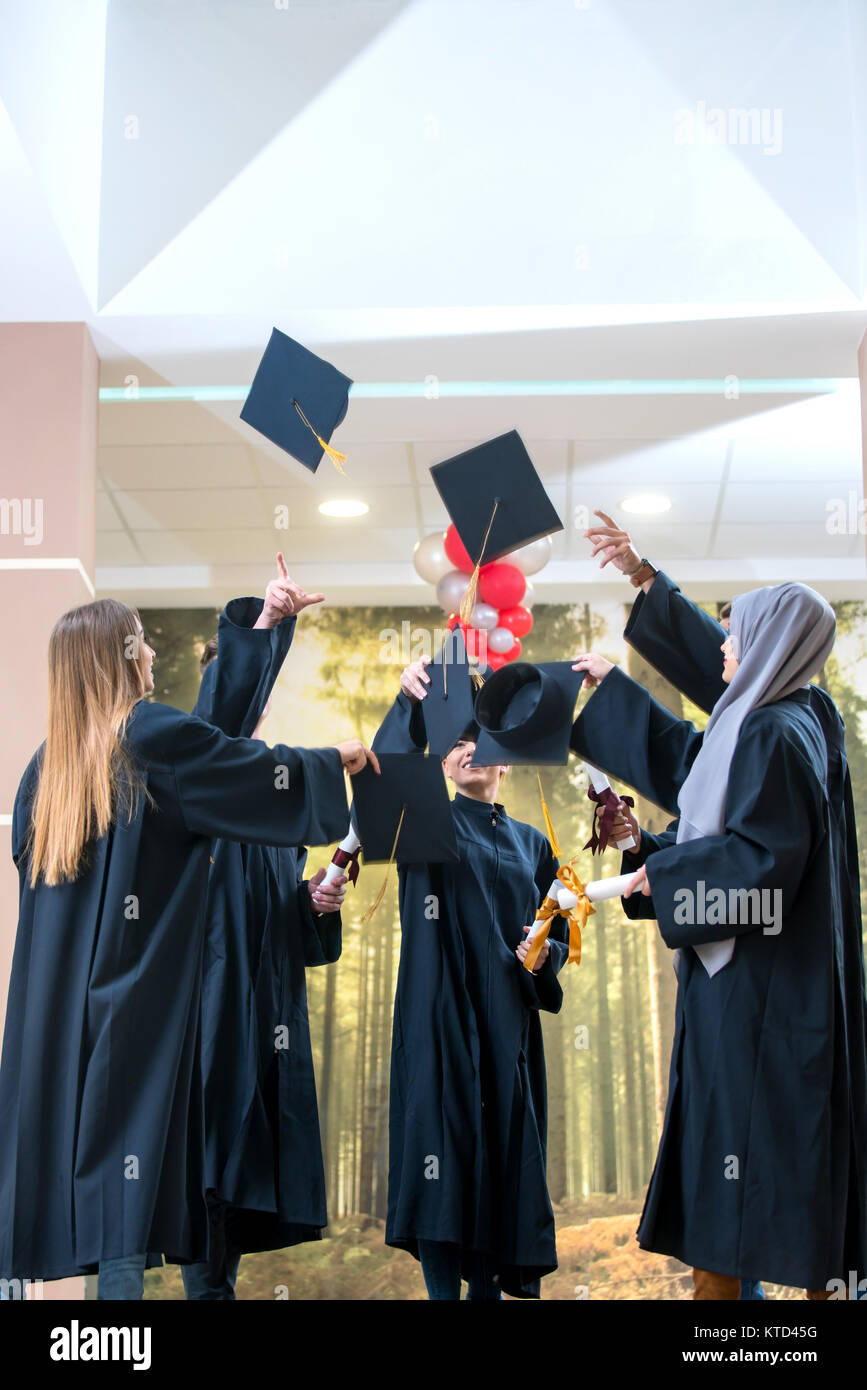 Group of Diverse International Graduating Students Celebrating, sitting ...