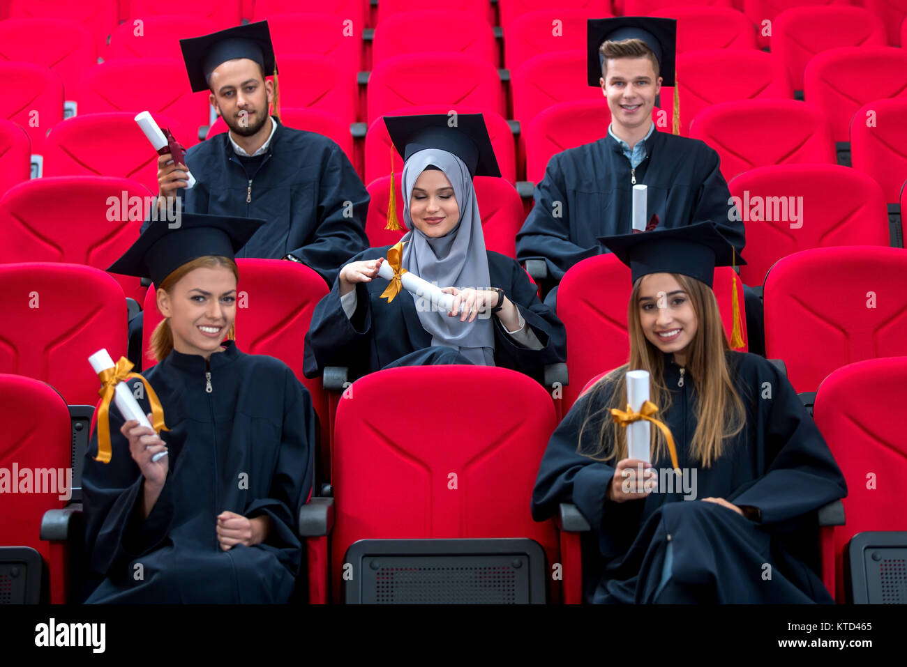 Group of Diverse International Graduating Students Celebrating, sitting ...