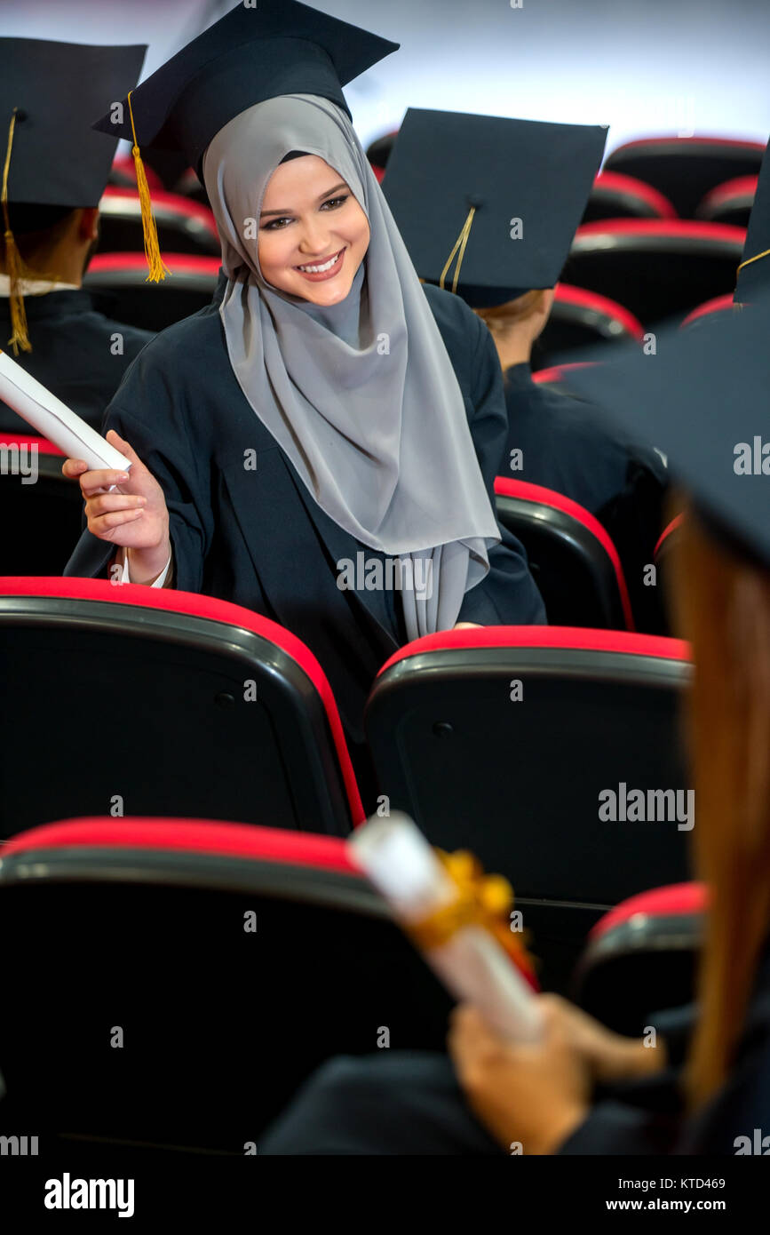 Group of Diverse International Graduating Students Celebrating, sitting ...