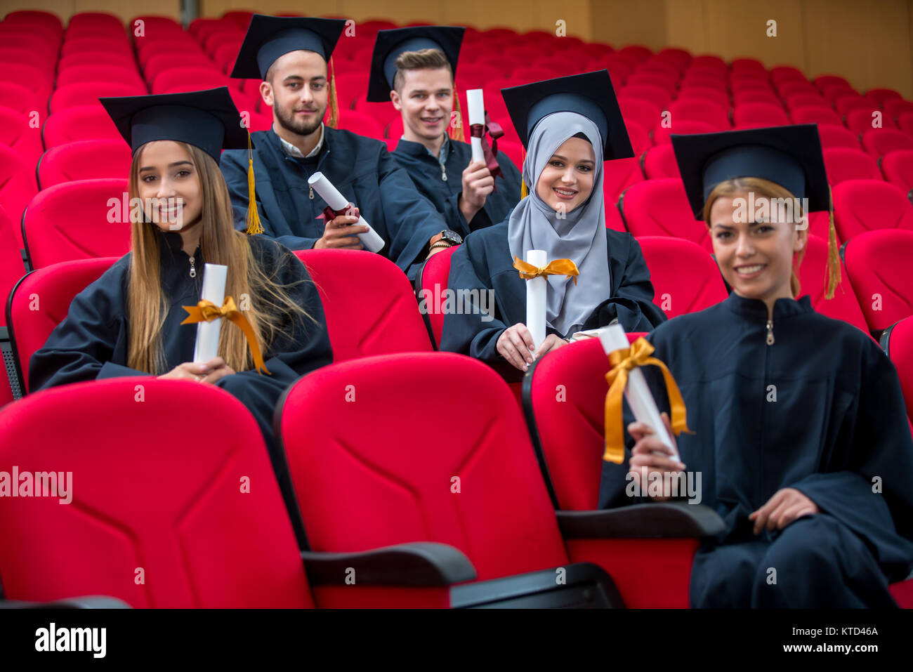 Group of Diverse International Graduating Students Celebrating, sitting ...