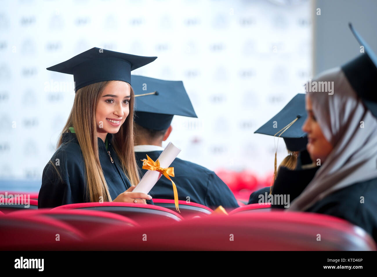 Group of Diverse International Graduating Students Celebrating, sitting ...