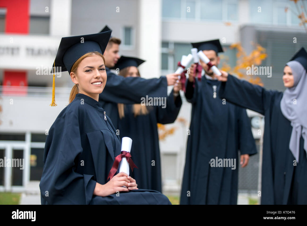 Group of Diverse International Graduating Students Celebrating, sitting ...