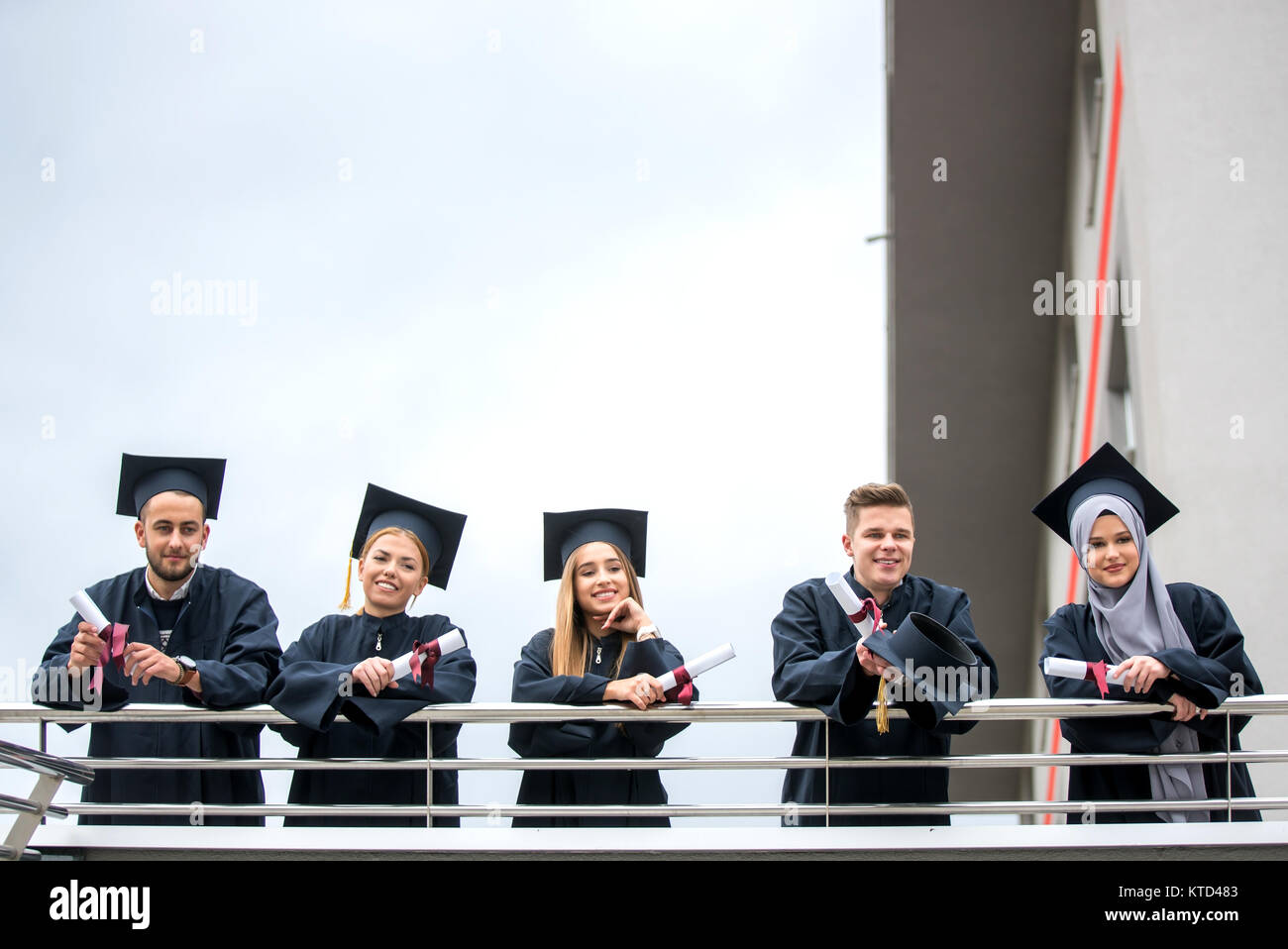 Group of Diverse International Graduating Students Celebrating, sitting ...