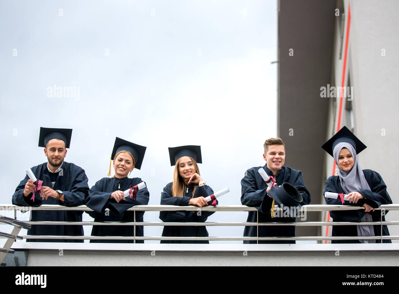 Group of Diverse International Graduating Students Celebrating, sitting ...
