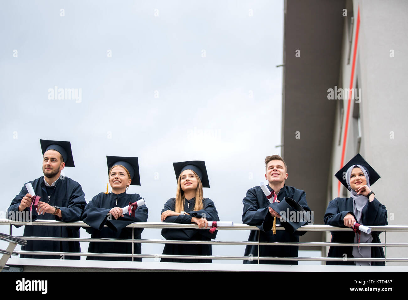 Group of Diverse International Graduating Students Celebrating, sitting ...