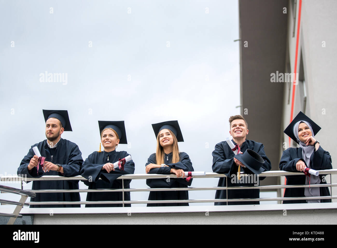 Group of Diverse International Graduating Students Celebrating, sitting ...
