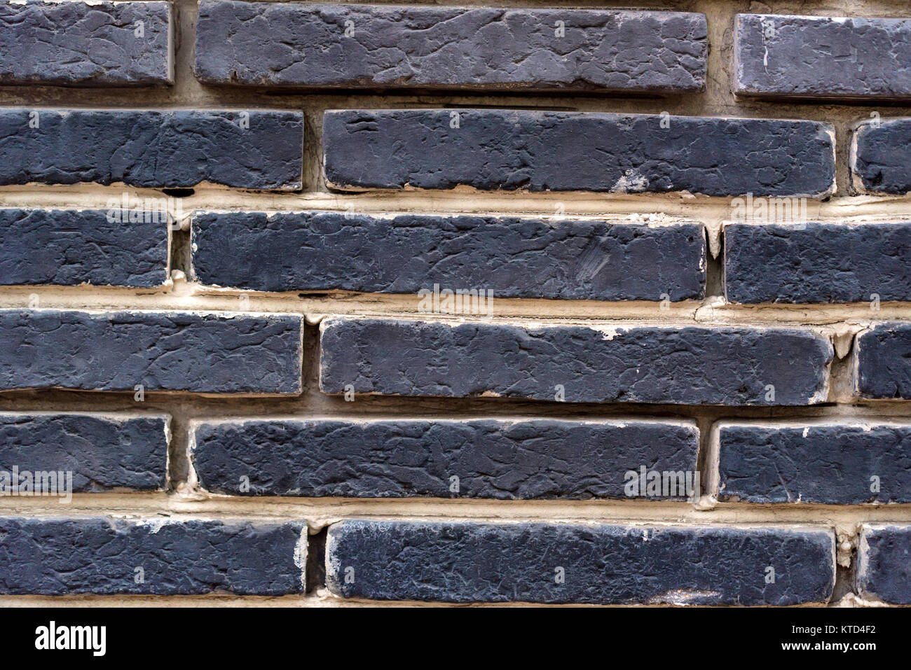 Old wall of dark gray stone bricks Stock Photo - Alamy