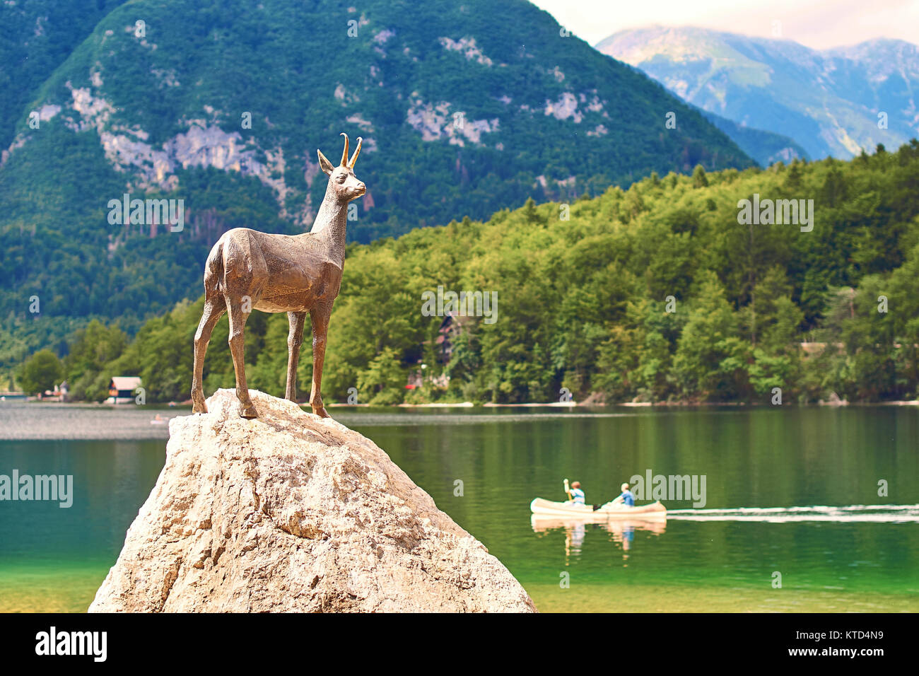 Bronze statue of Goldhorn Zlatorog deer next to the Bohinj Lake in ...