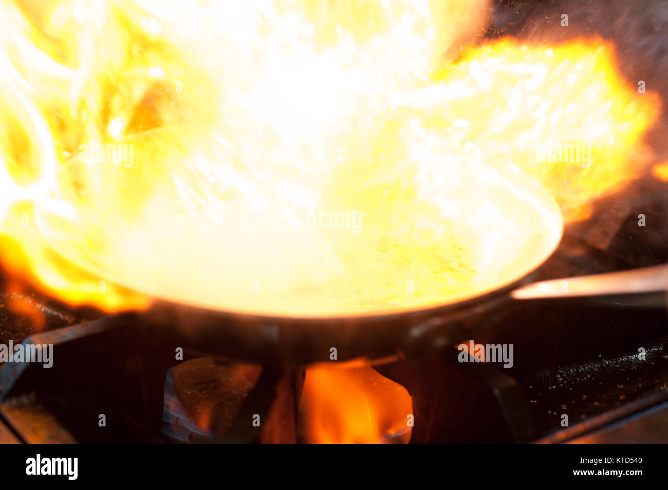 Flambe flame from a saute pan Stock Photo - Alamy