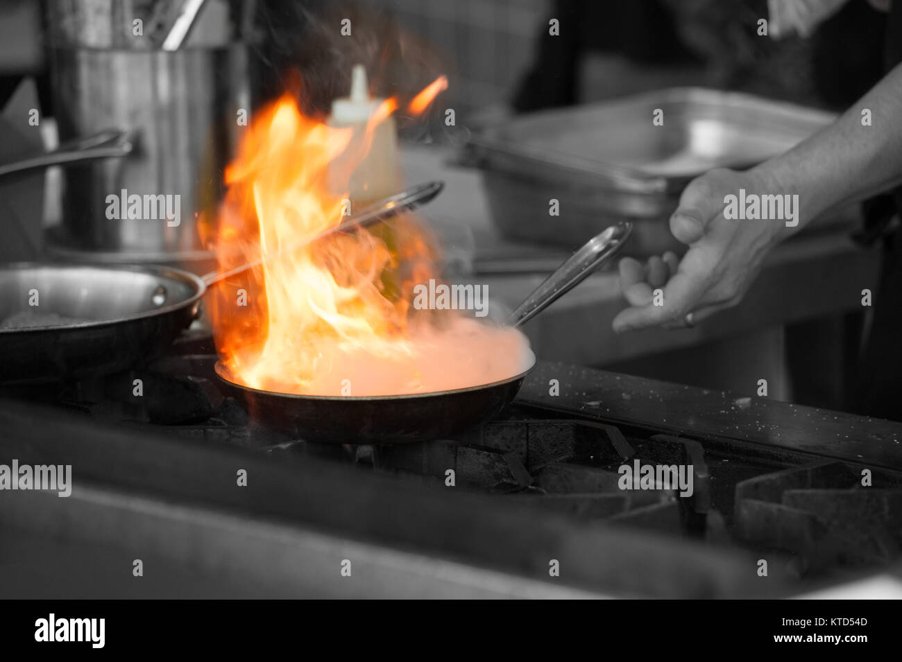 Flambe flame from a saute pan Stock Photo - Alamy