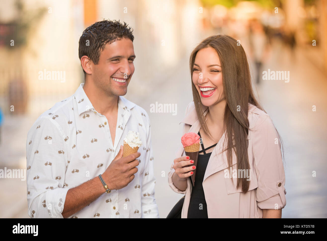 Cheerful couple eating ice cream cones Stock Photo - Alamy