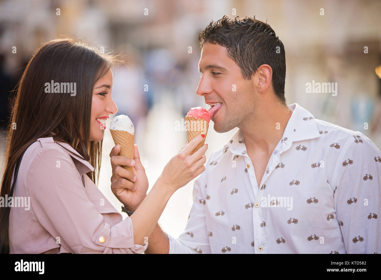 Cheerful couple eating ice cream cones Stock Photo - Alamy